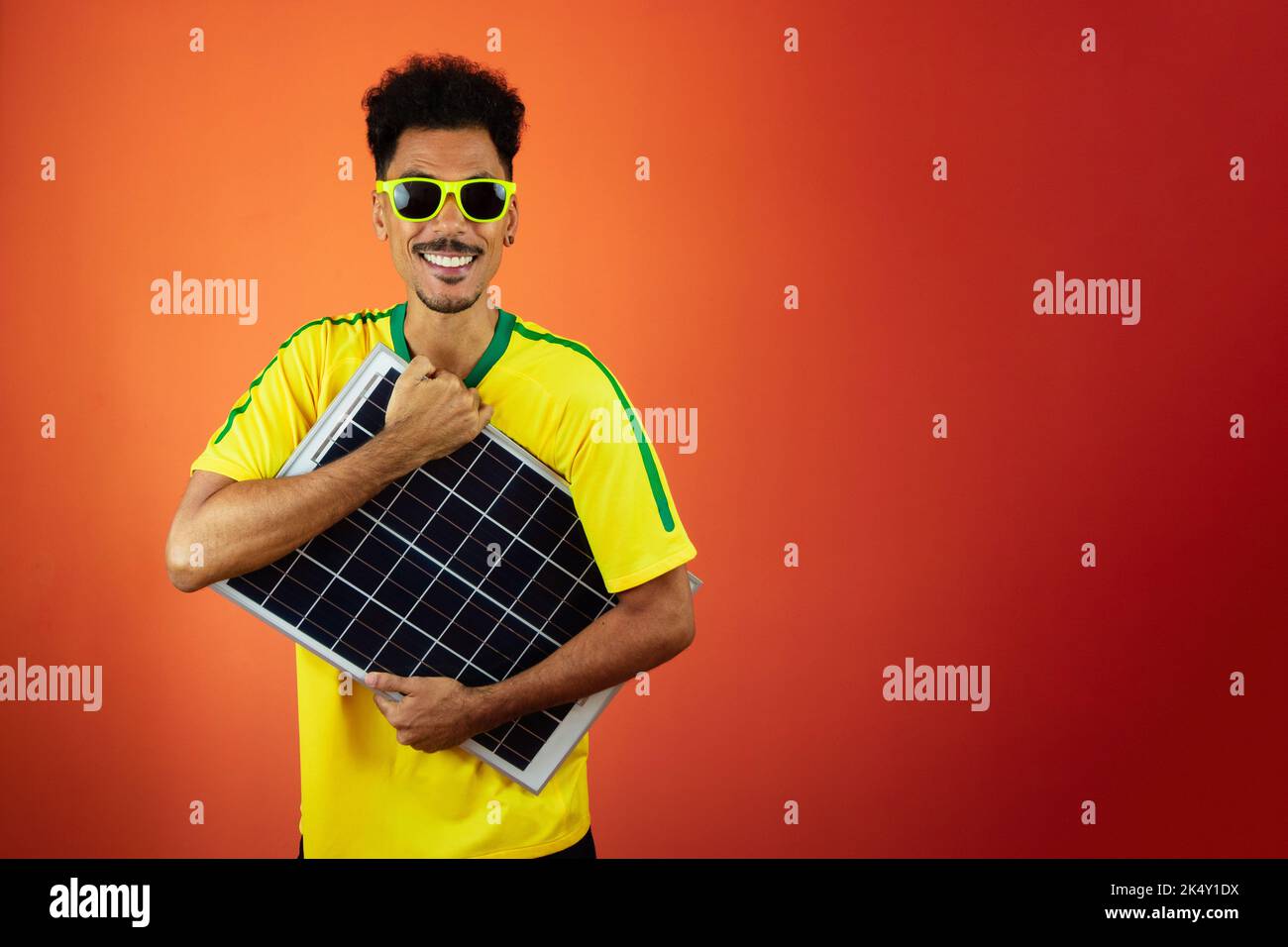Soccer Player - Black Man Celebrating Holding Solar Photovoltaic Panel ...