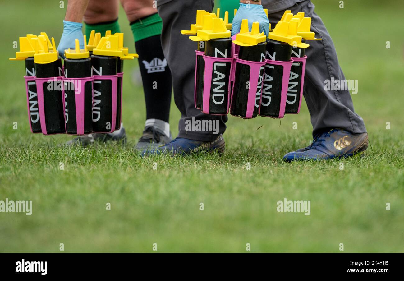 Rugby support team member carrying plastic Ziland water bottles Stock ...