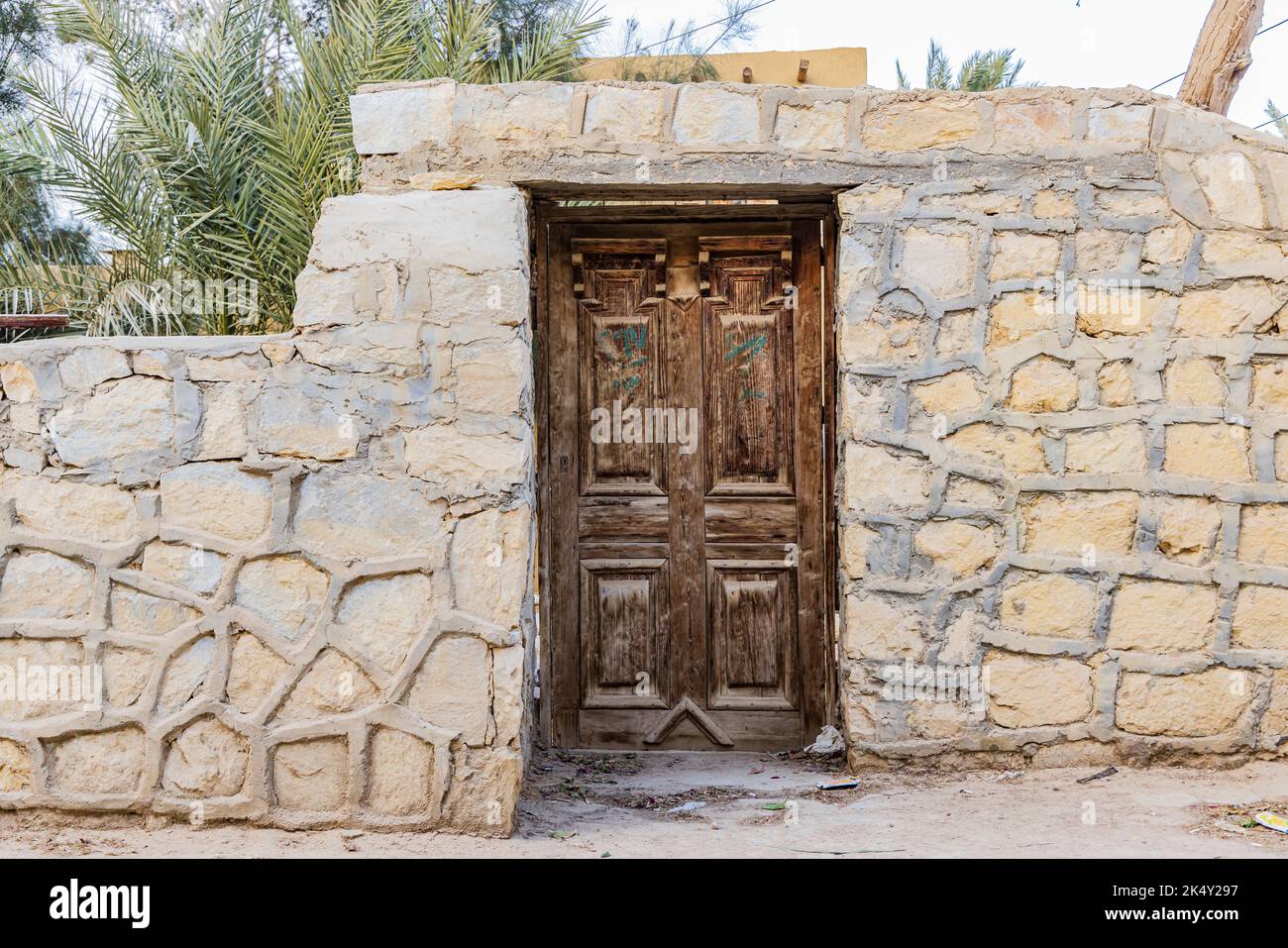 Faiyum, Egypt. Wooden door in a wall in the village of Faiyum Stock ...