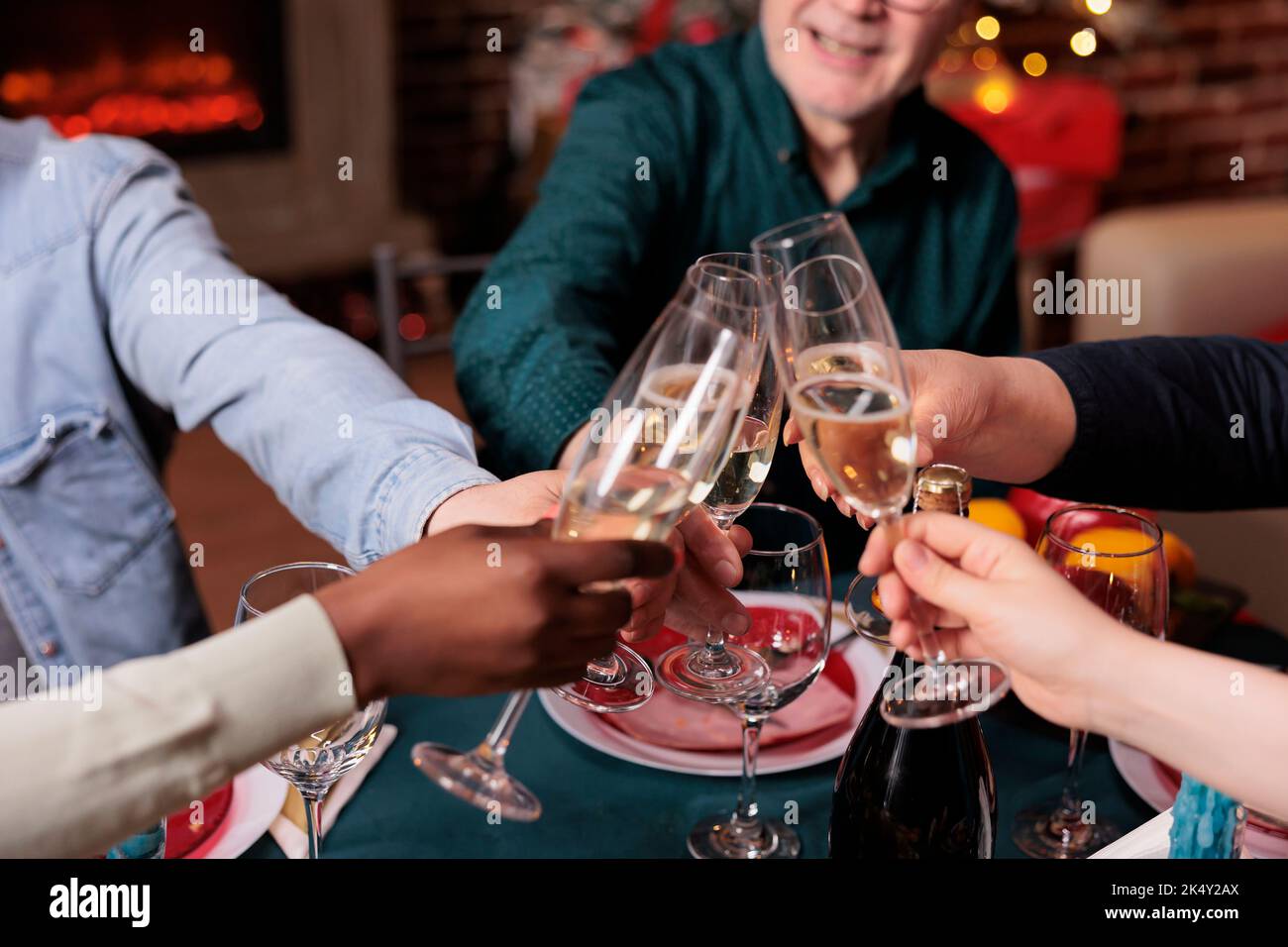 Diverse people clinking glasses with sparkling wine close up, proposing ...