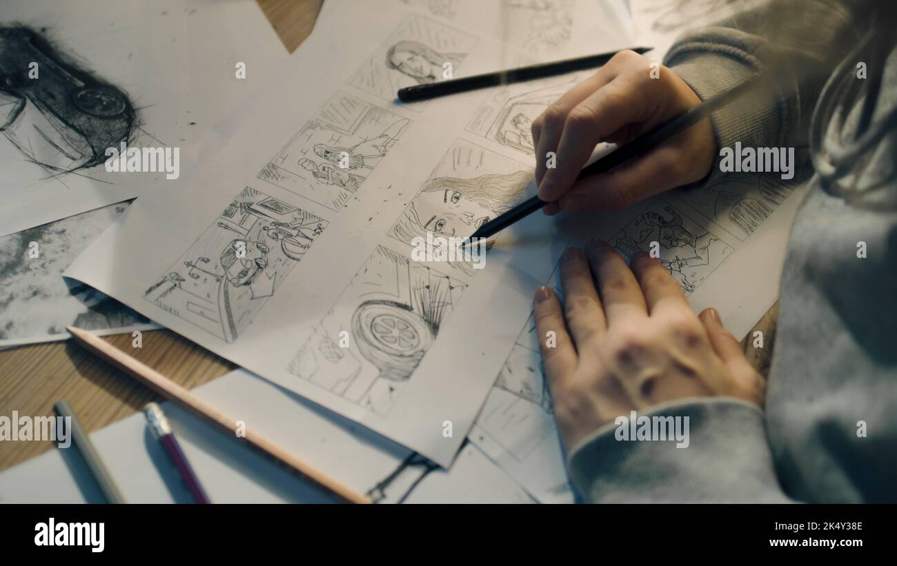 Young female artist draws sketches of comic book characters on a sheet ...