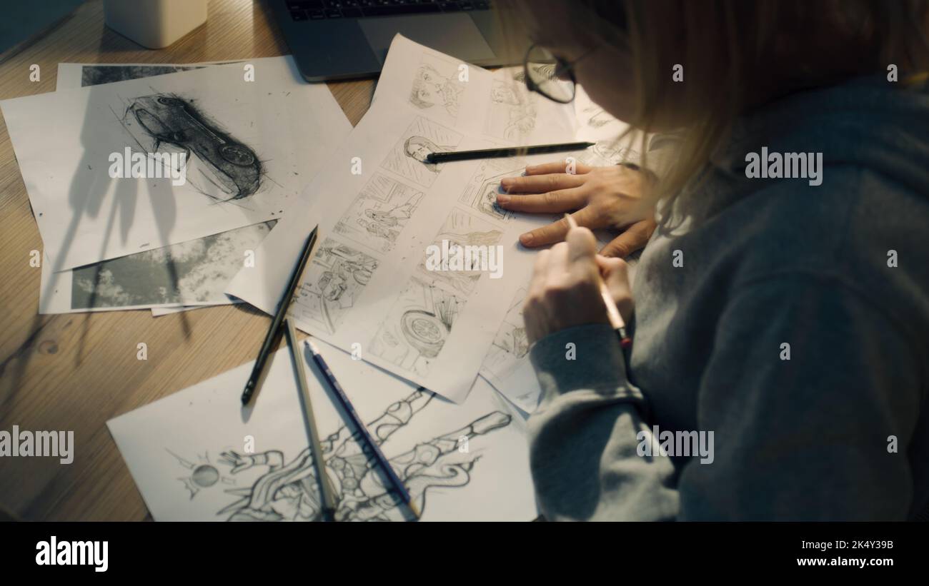 Female creative designer works on a storyboard and draws a sketches for ...