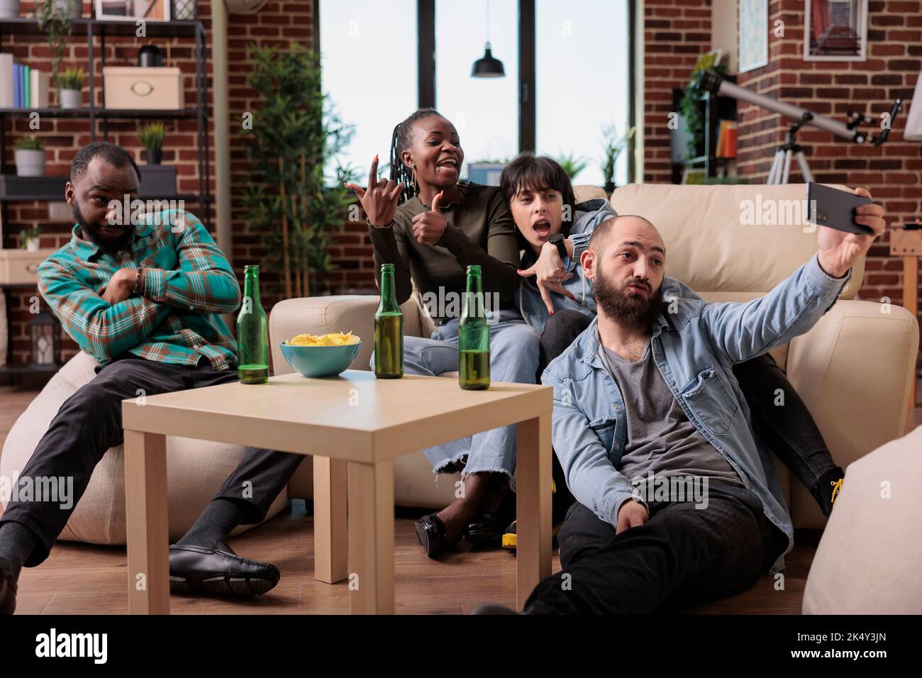 Young people having fun with photos taken on smartphone camera ...