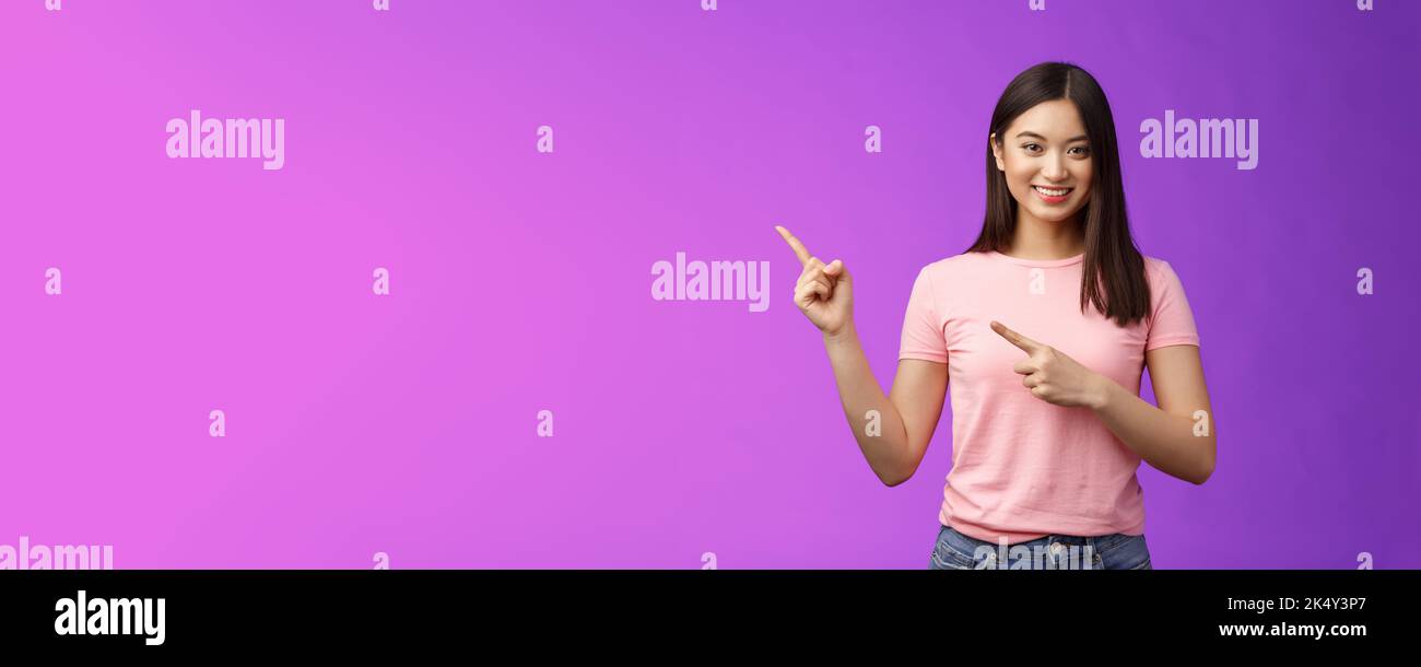 Friendly cute pleasant asian woman showing way, indicating interesting ...