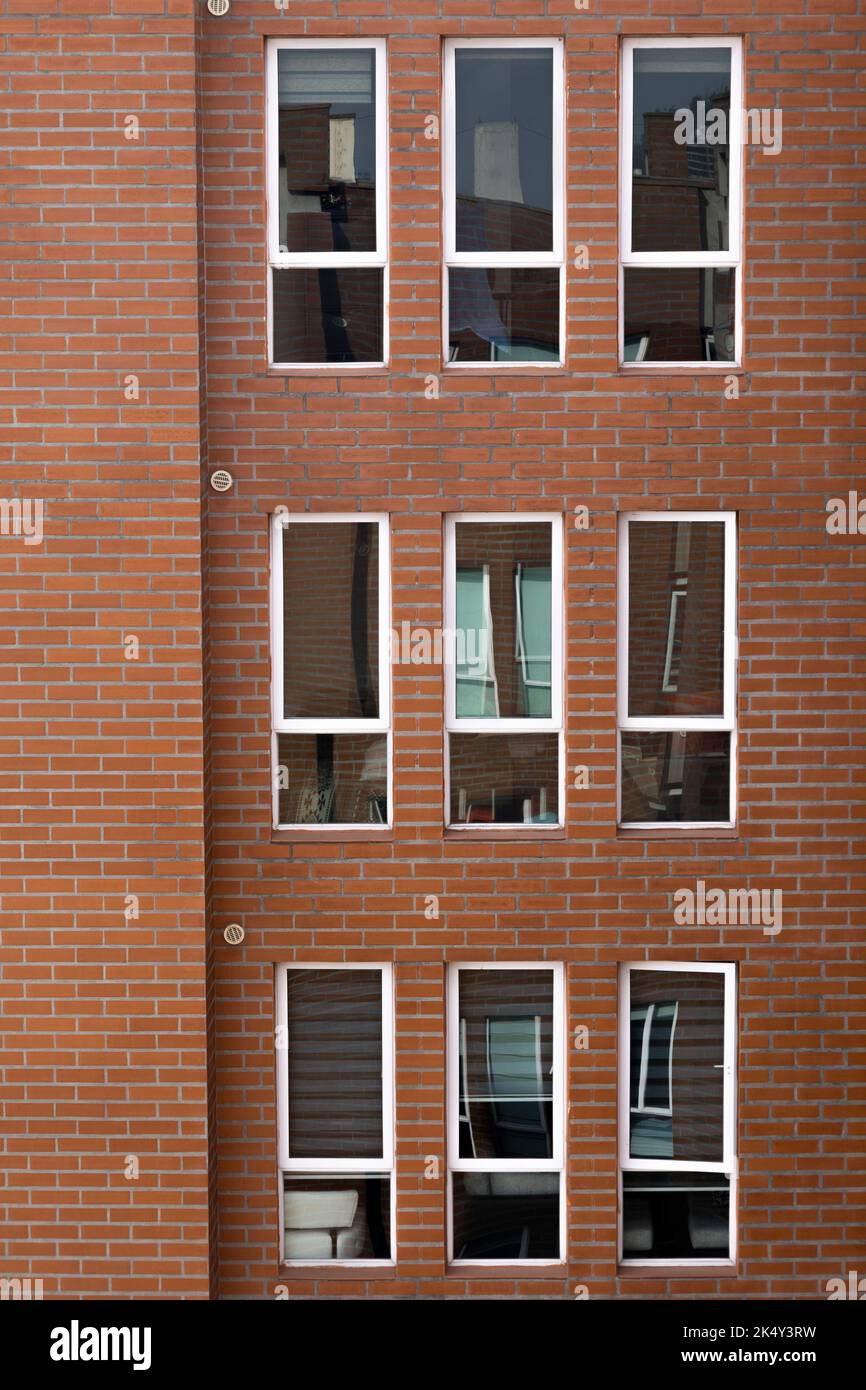 residential apartment with windows and brick wall, background with ...