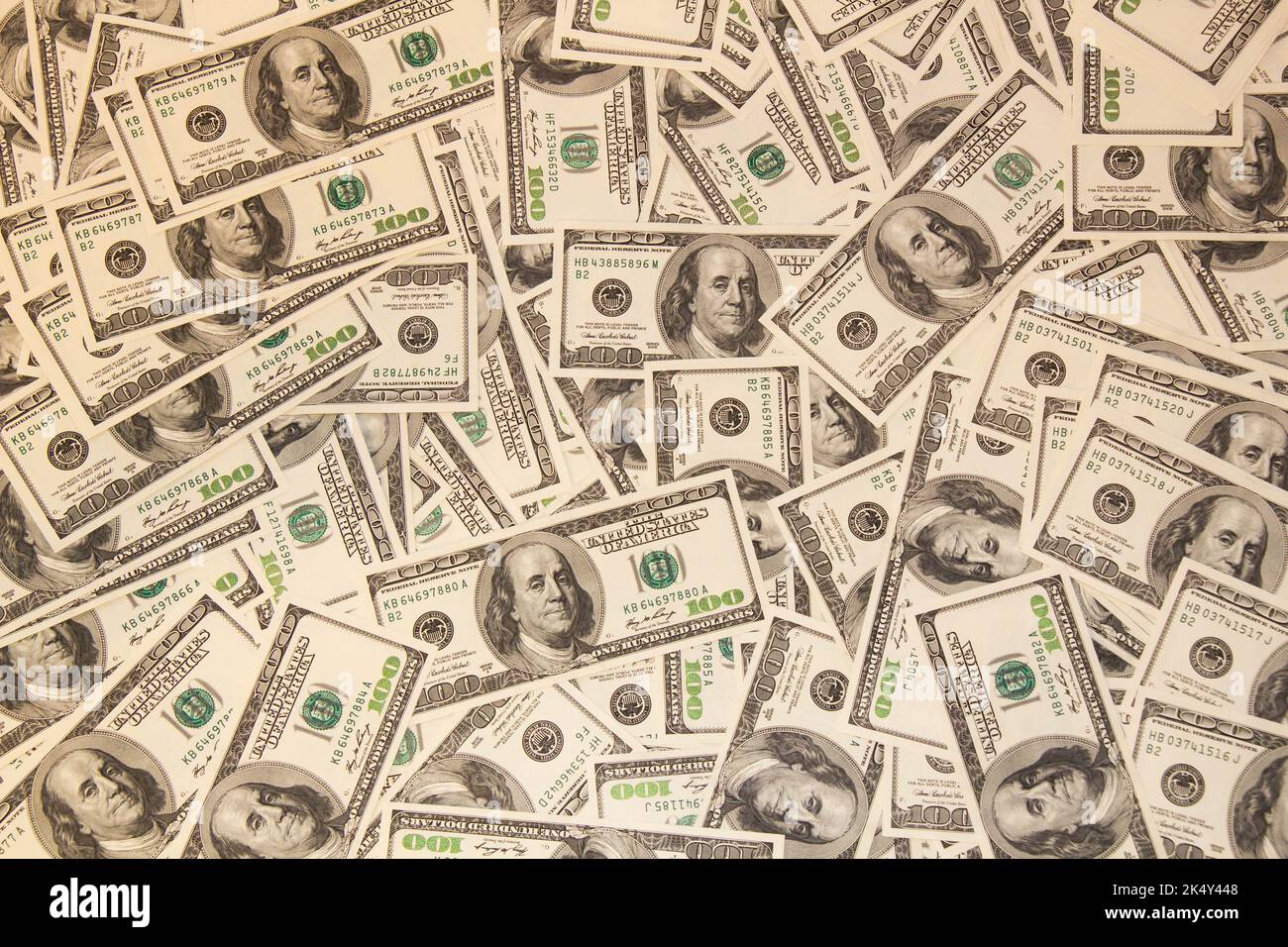 Many hundred dollar bills on the table. One hundred US dollar bills ...