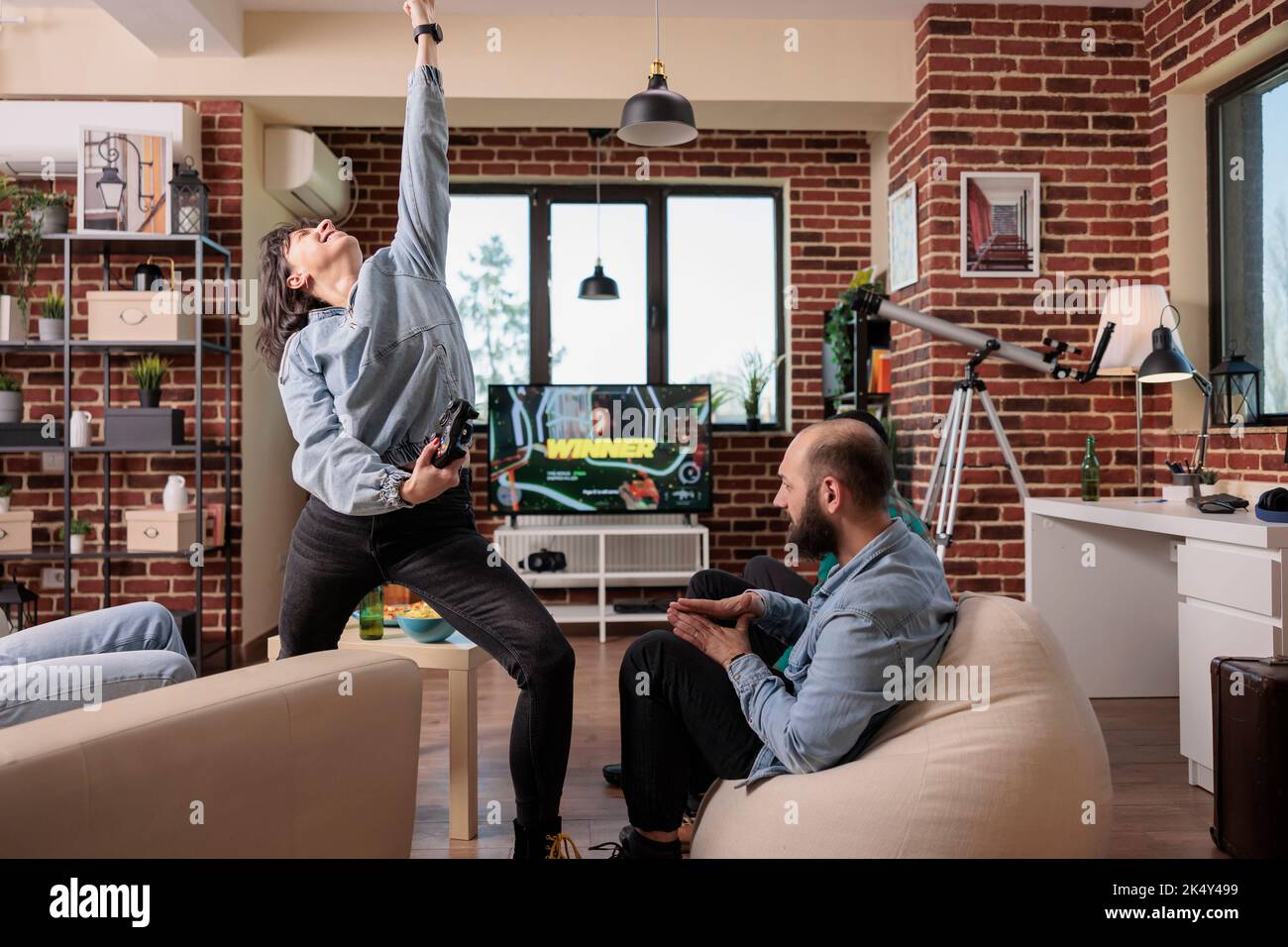 Smiling adult celebrating video games victory on tv console, playing ...