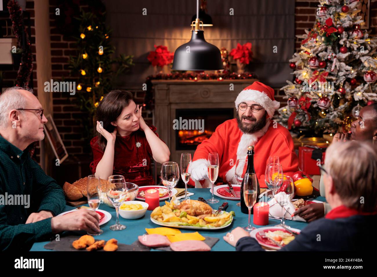 Man wearing santa claus costume celebrating christmas with family ...