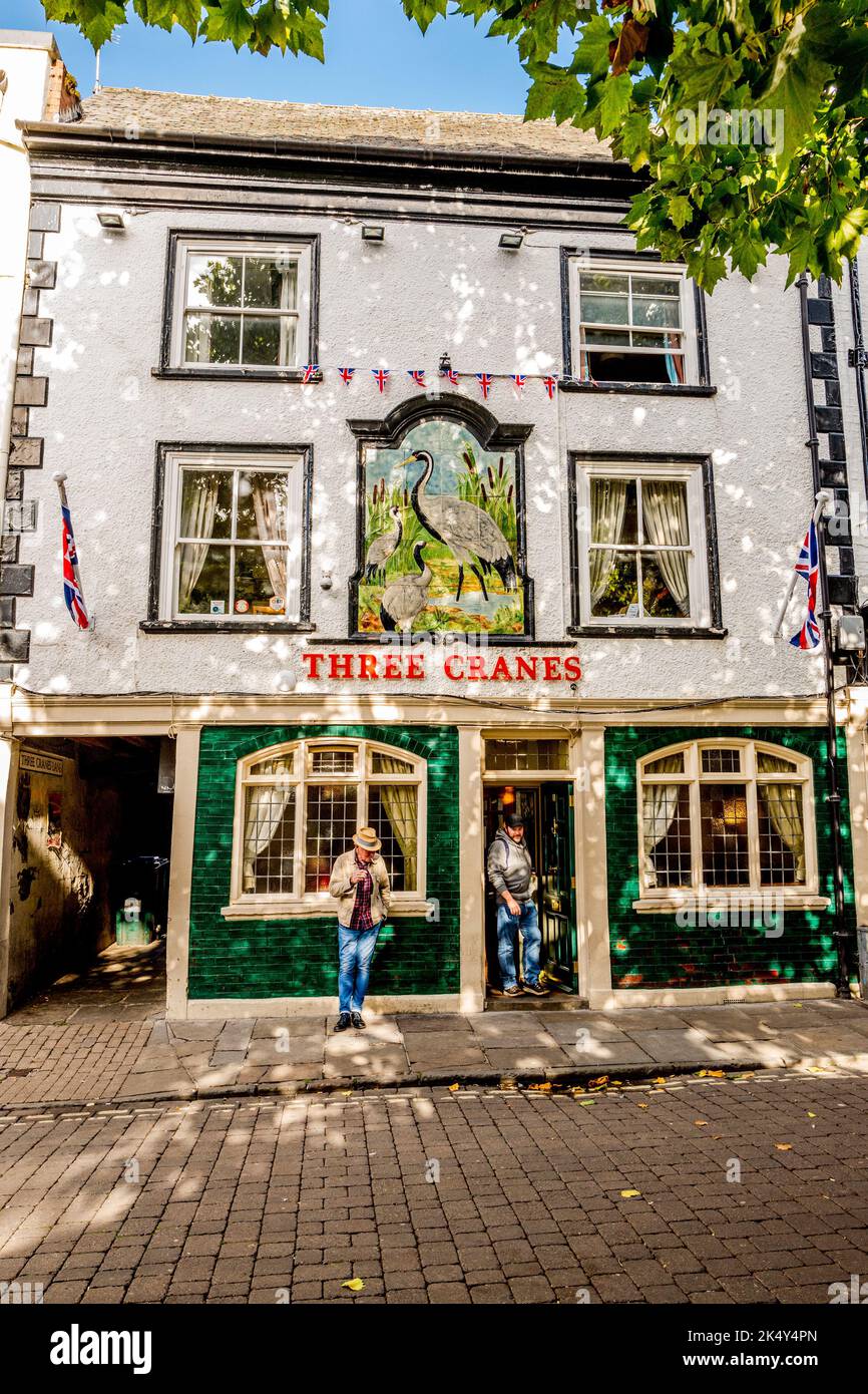 Male standing outside the Three Cranes Inn, public house or pub smoking ...