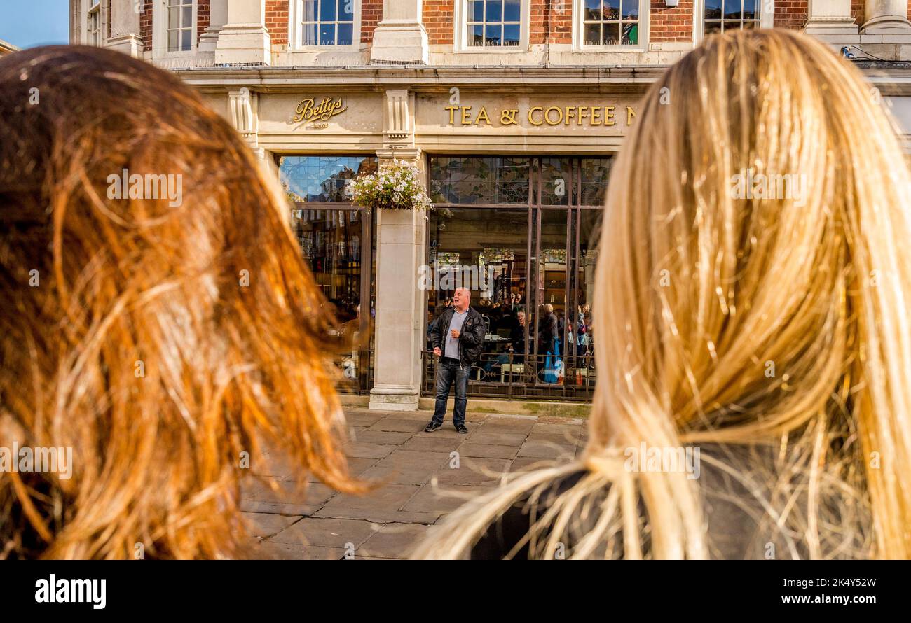Male busker singing in the market square outside the famous Bettys tea ...