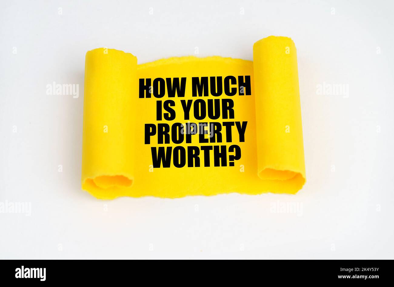 On a white surface, a yellow scroll of paper with the inscription - HOW ...