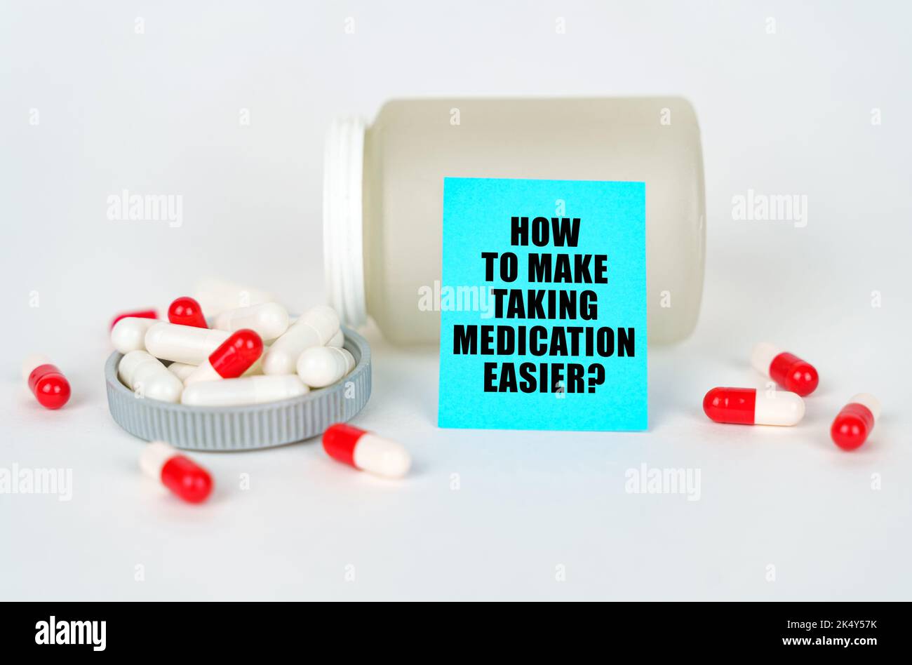 Medical concept. On a gray background, a jar, capsules and a sign with ...