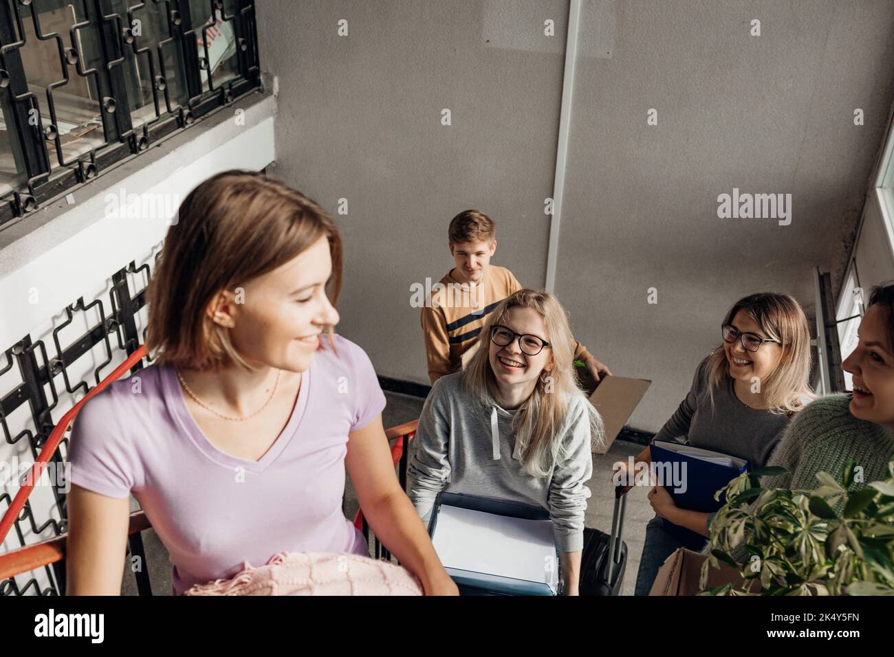 Smiling, glad, foretaste, anticipating students carrying luggage and ...