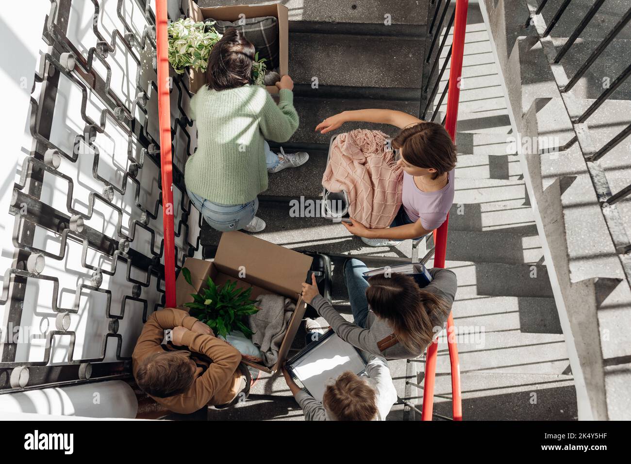 Top view people carrying luggage and stuff in cardboard boxes on stairs ...