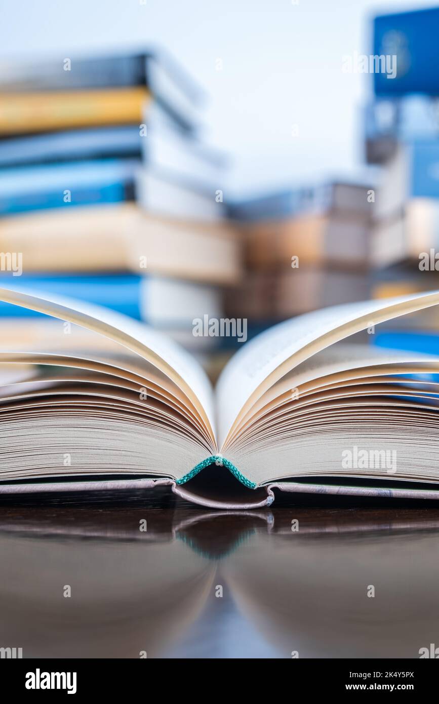 Closeup opened book on library desk Stock Photo - Alamy