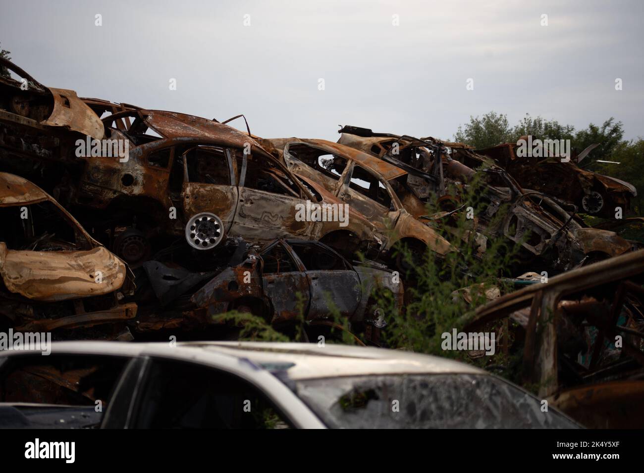 A bunch of wrecked and burned civilian cars in the city of Gostomel ...