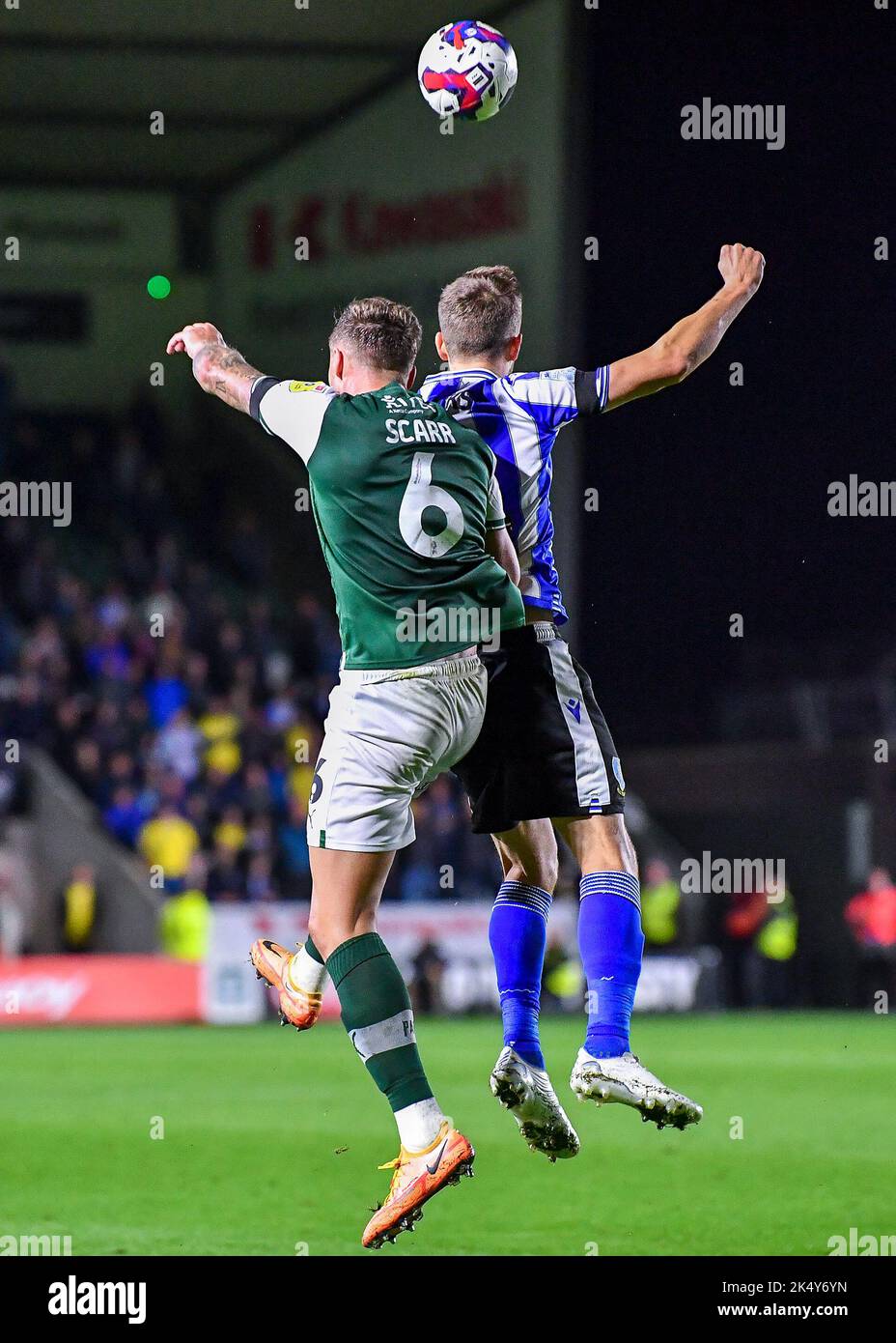 Plymouth Argyle defender Dan Scarr (6) battles in the air during the ...