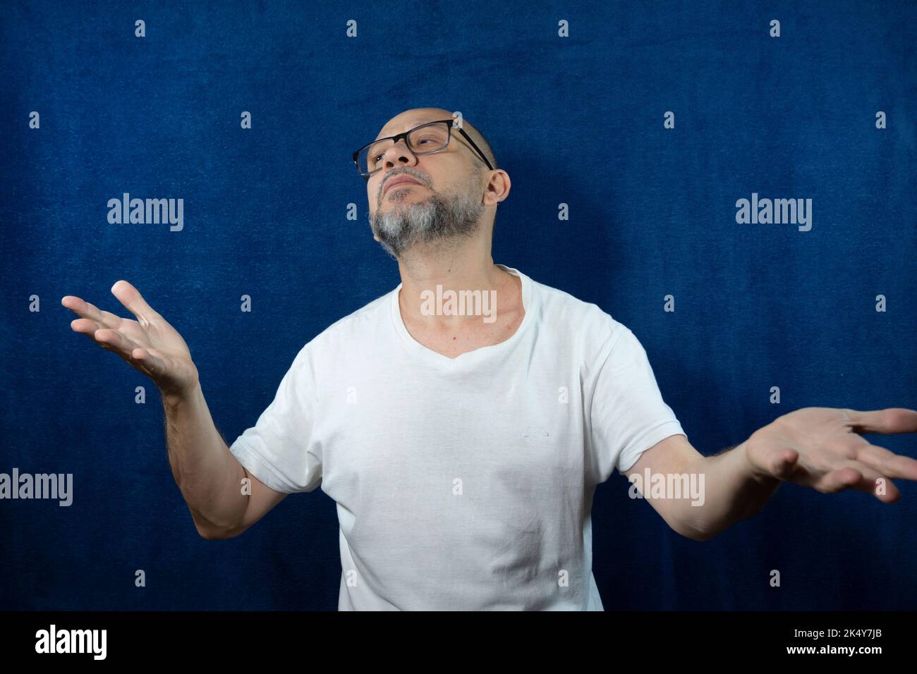 Portrait of a bearded bald man against blue background Stock Photo - Alamy