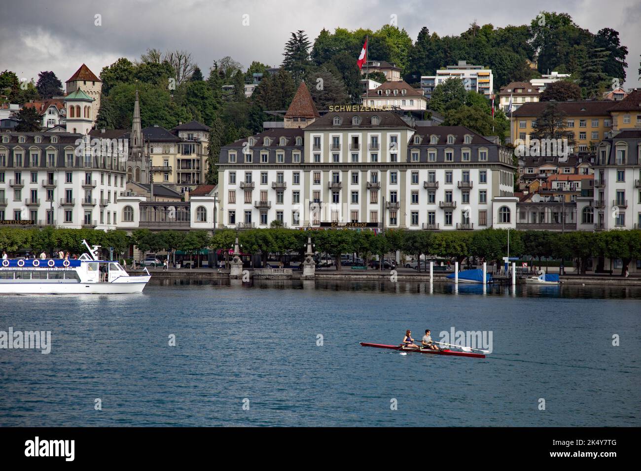 The city of Lucerne on the shore of Lake Lucerne with kayakers, boats ...