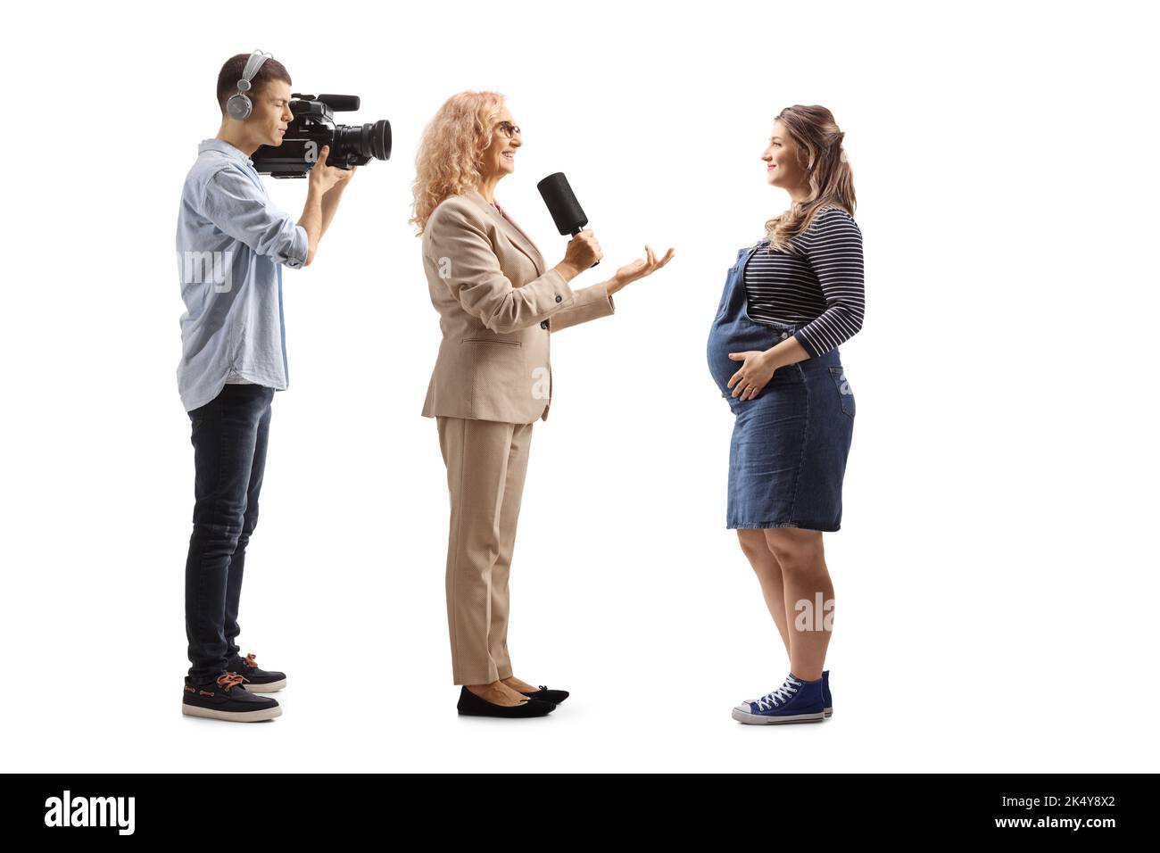 Female reporter interviewing a pregnant woman and camera man recoridng ...