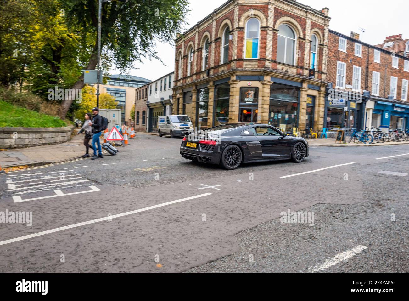 Black Audi R8 sports car being driven along the streets in the acient ...