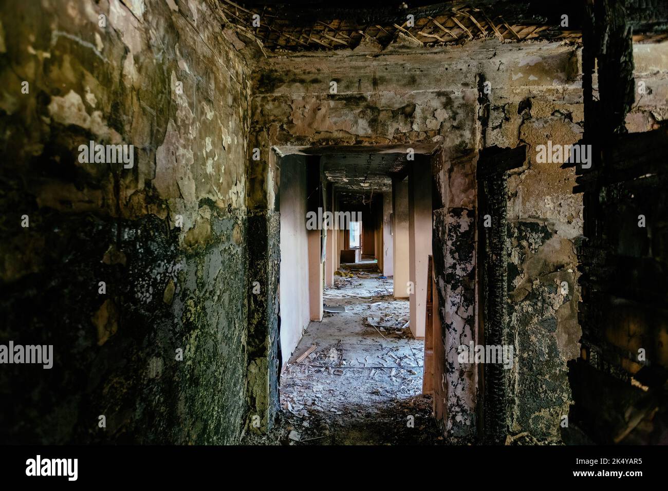 Burnt building interior. Ruined coridor walls in black soot ...