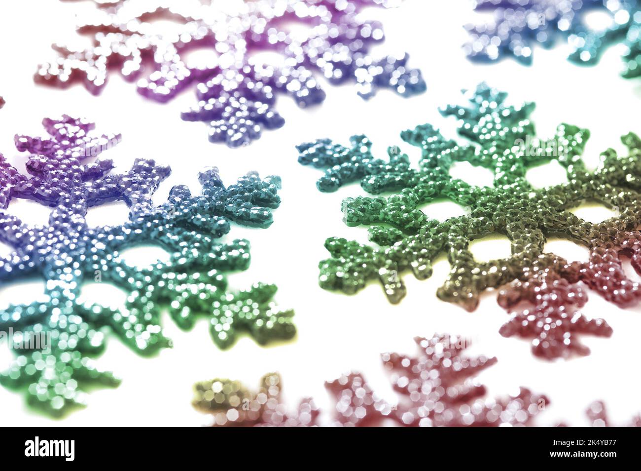 a background image of multi-colored snowflake shaped decorations Stock ...