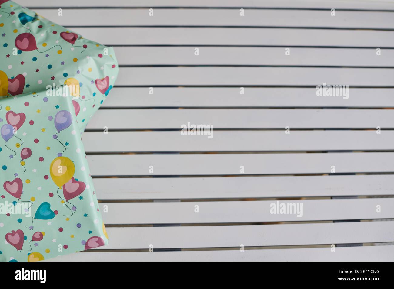 Horizontal shot of two presents wrapped situated on the left side of a ...