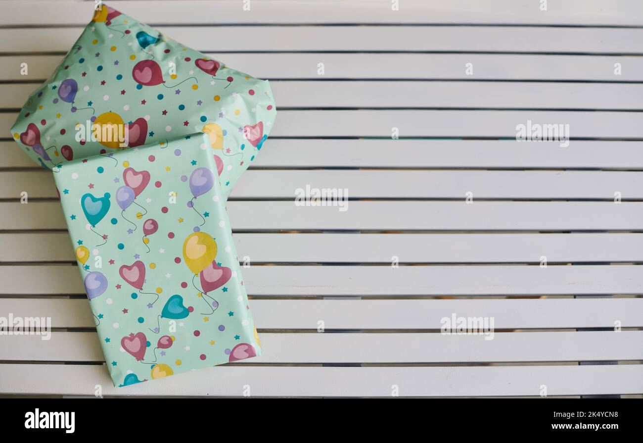 Horizontal shot of two presents wrapped situated on the left side of a ...