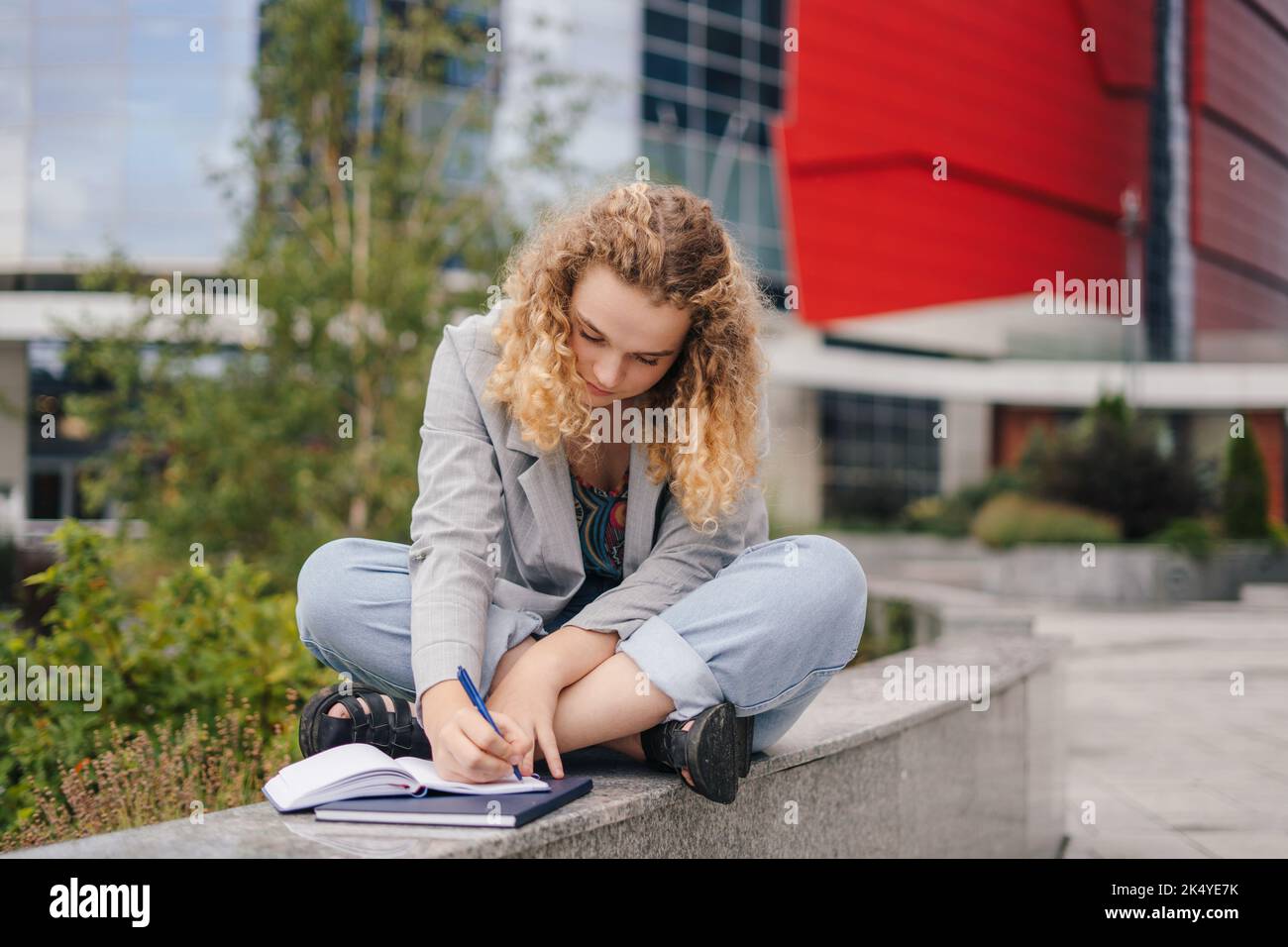 Caucasian woman university student with notebooks learning at campus ...