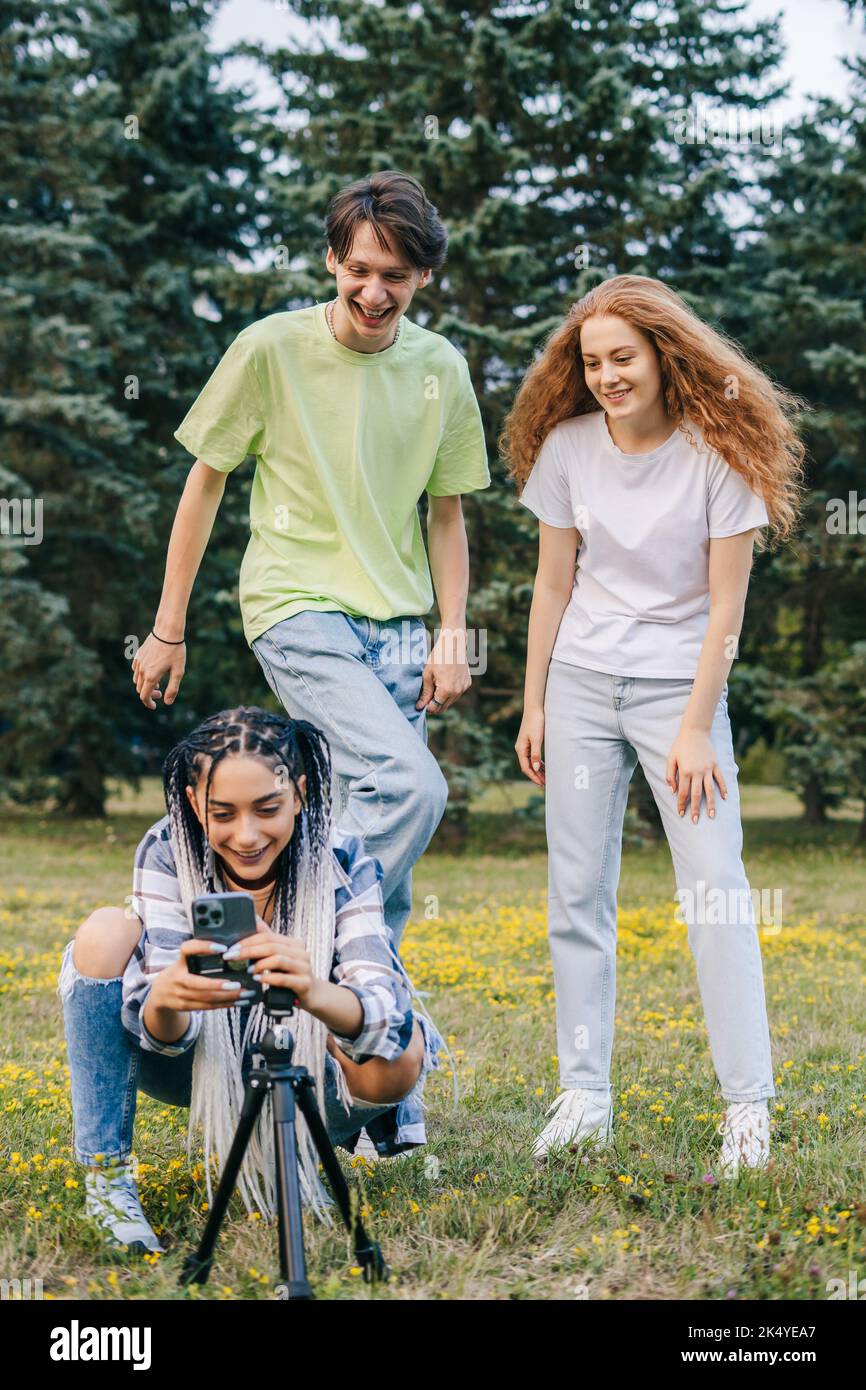 Three young teenagers influencers creating their dancing video by ...