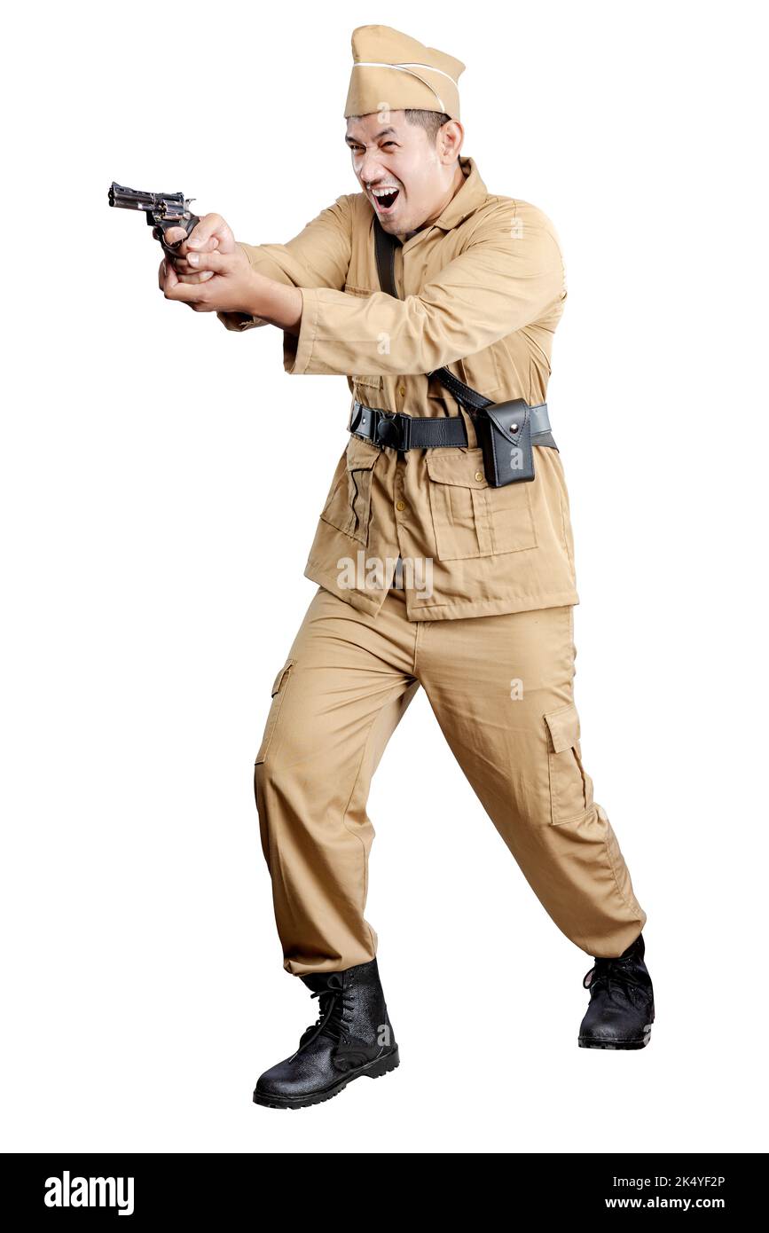 Indonesian freedom fighter standing while holding gun isolated over ...