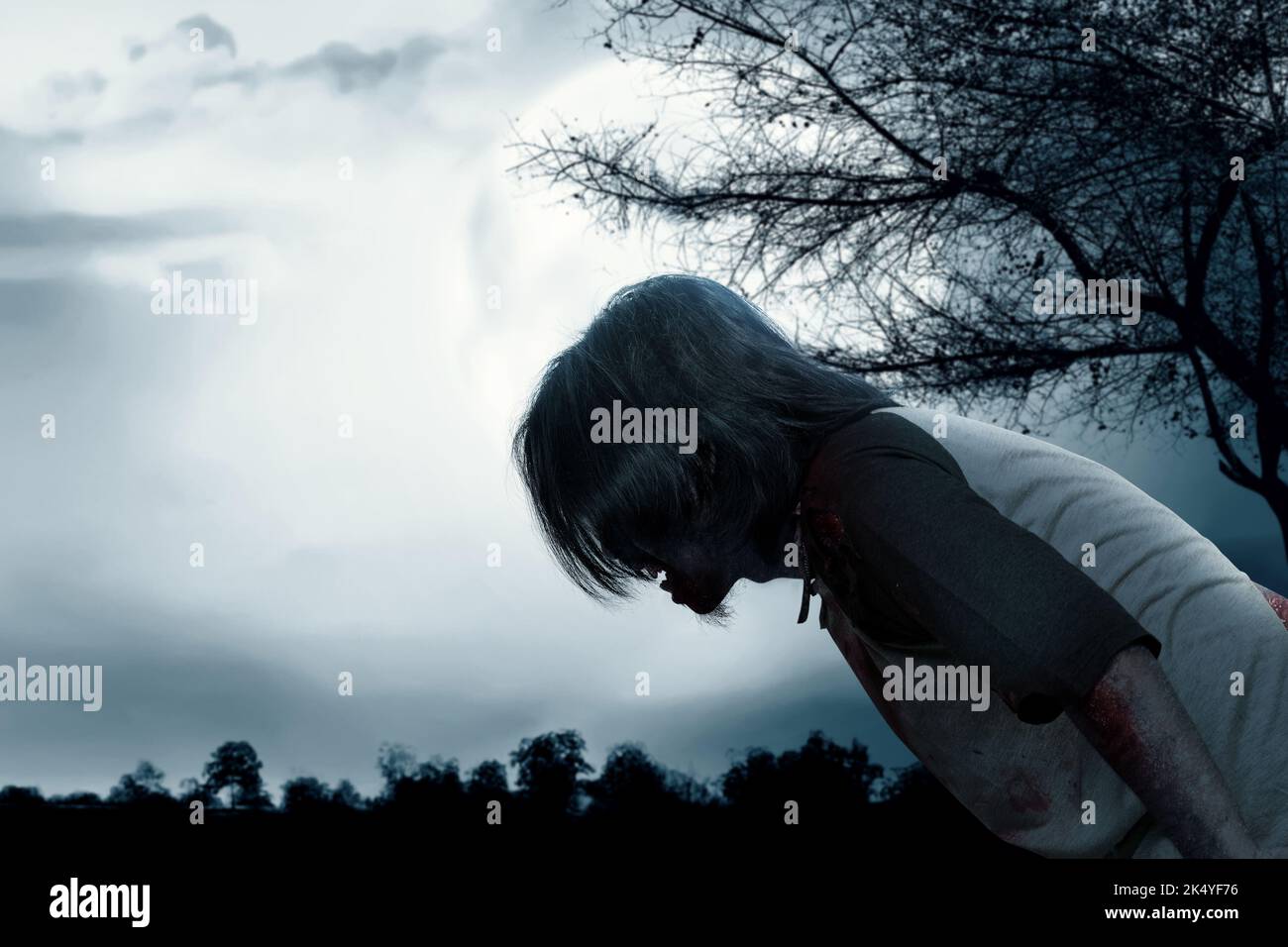 Scary zombie with blood and wound on his body walking with full moon ...
