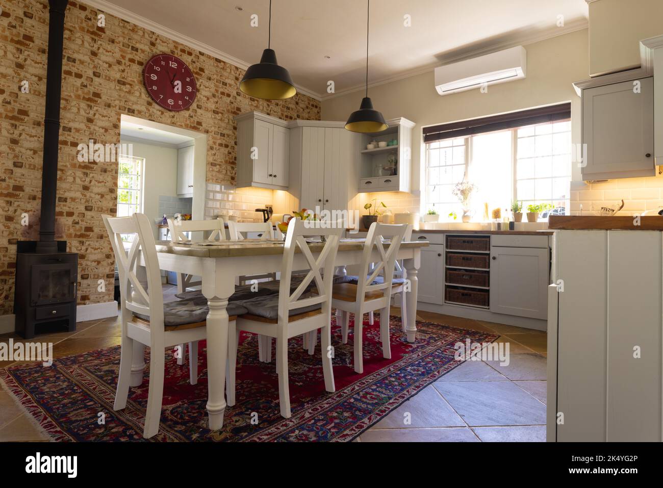 General view of kitchen interior with cupboards, countertop and table ...