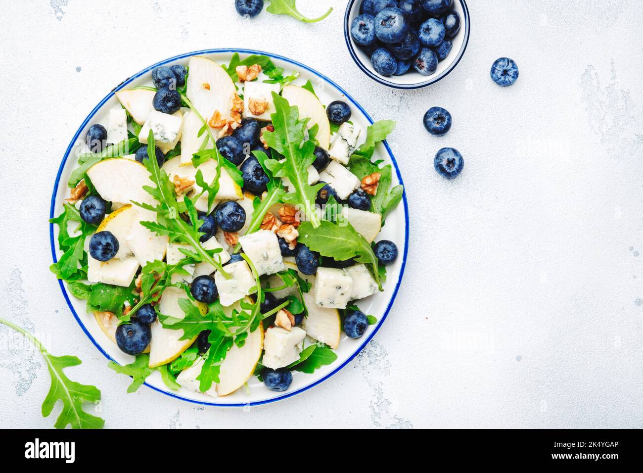 Delicious arugula salad with pears, blueberries, roquefort cheese and ...
