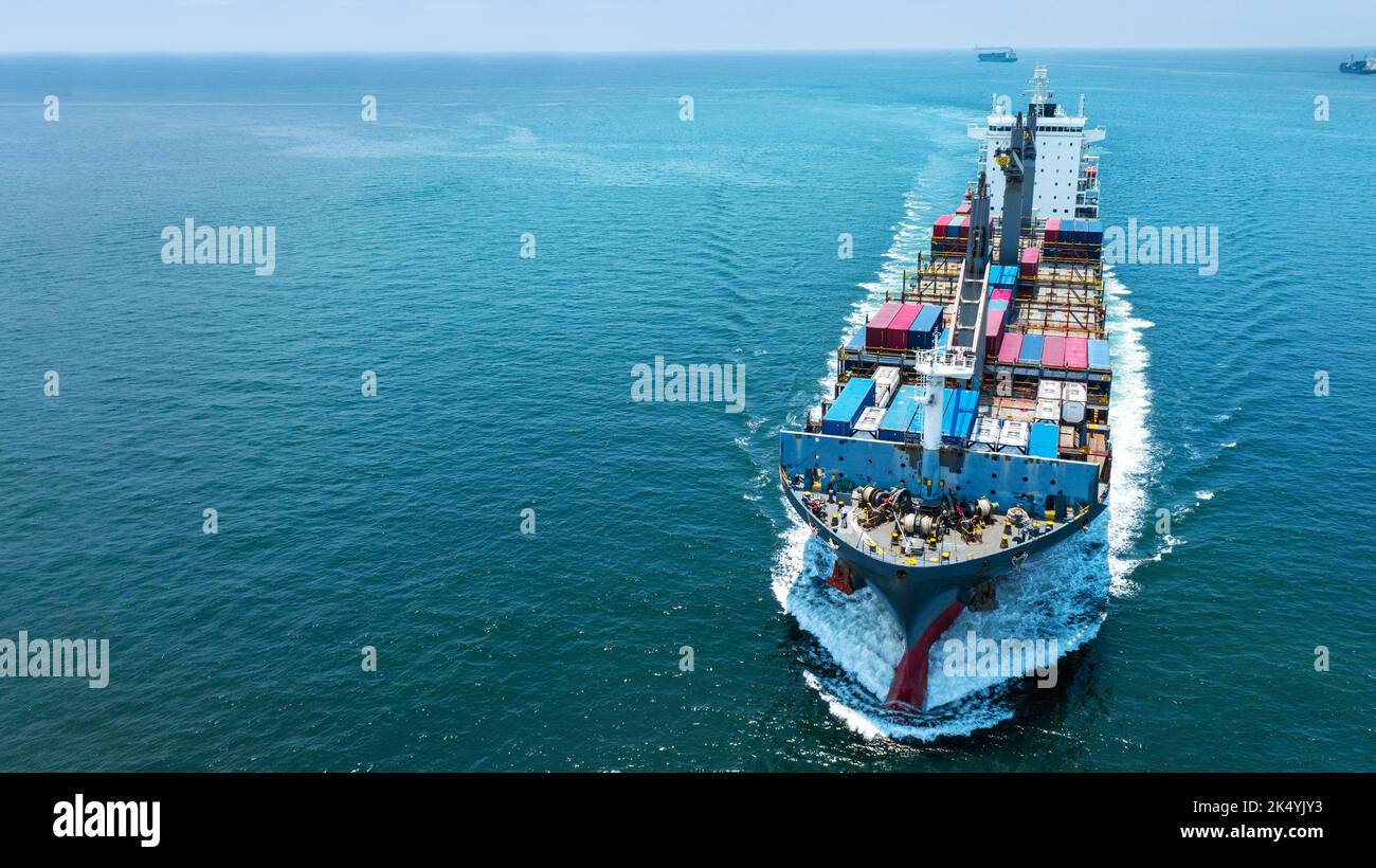 Aerial front of cargo ship carrying container and running near ...
