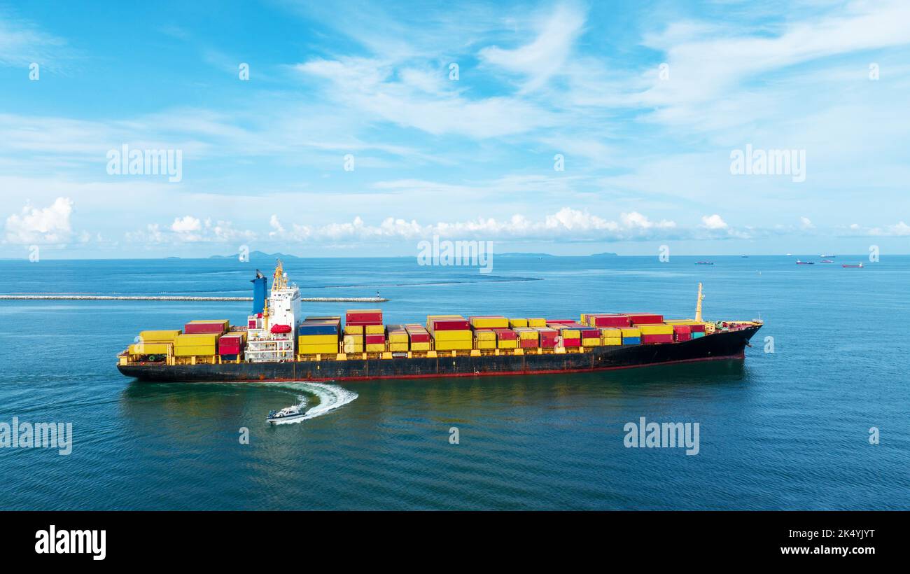 Side of cargo ship carrying container and running near international ...