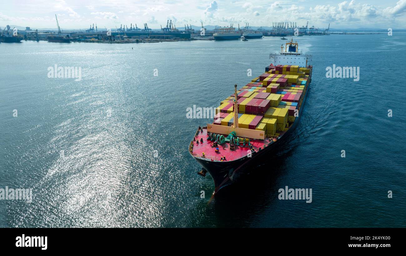 Aerial front of cargo ship carrying container and running near ...