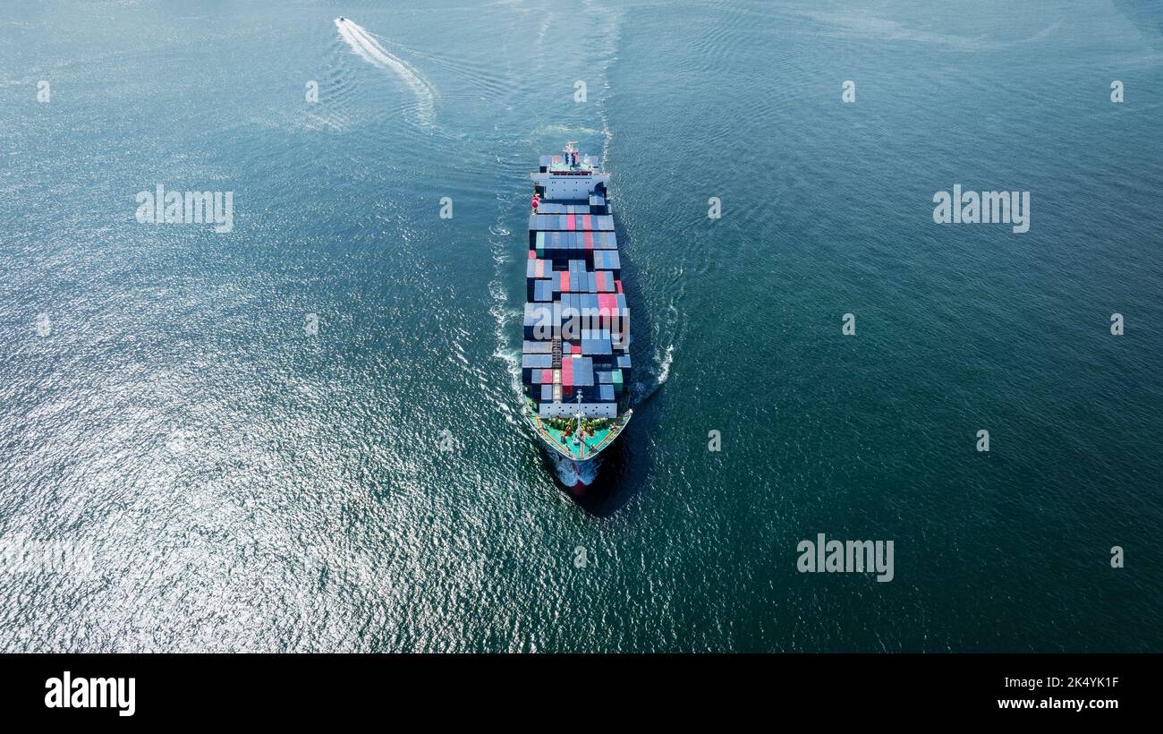 Aerial front of cargo ship carrying container and running near ...