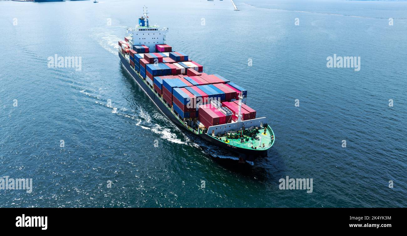 Aerial front of cargo ship carrying container and running near ...