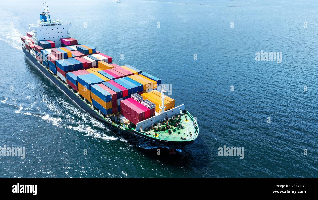 Aerial front of cargo ship carrying container and running near ...