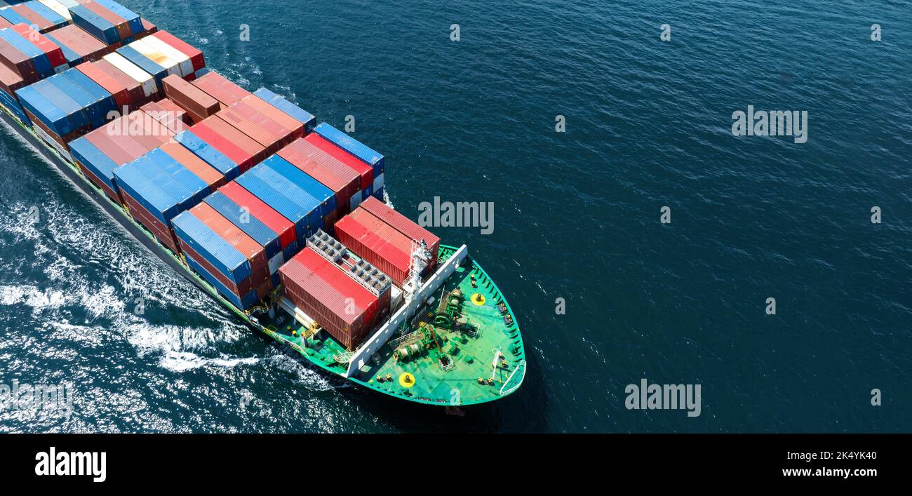 Aerial front of cargo ship carrying container and running near ...