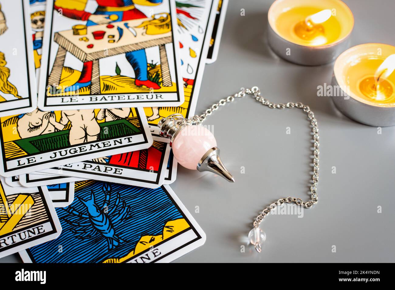 Fortune telling. Tarot de Marseille and divinatory pendulum Stock Photo ...