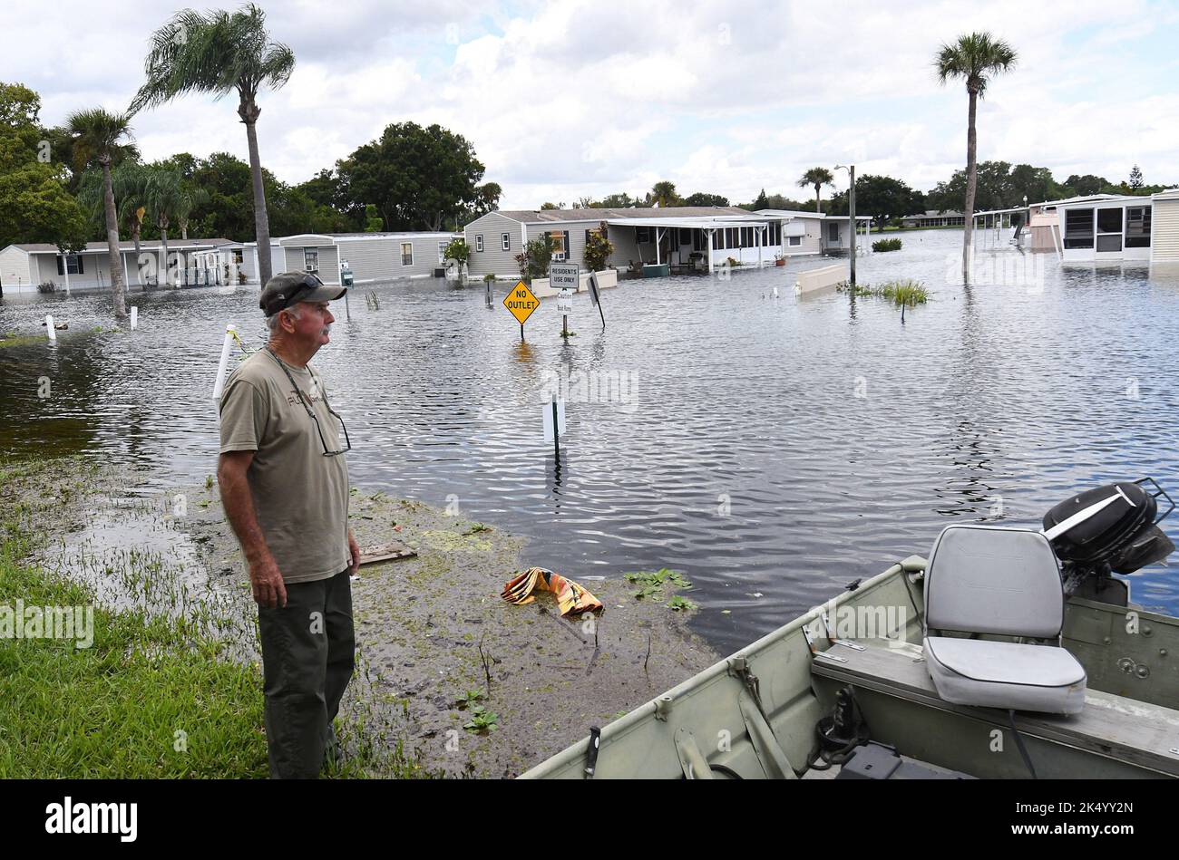 Kit Brown stands near his boat in the flooded Jade Isle Mobile Home ...
