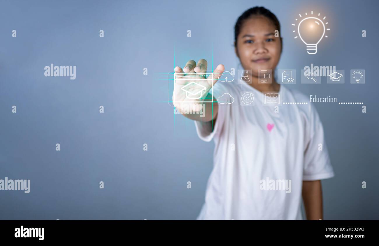 Educational concept picture. A girl stands holding an education icon ...