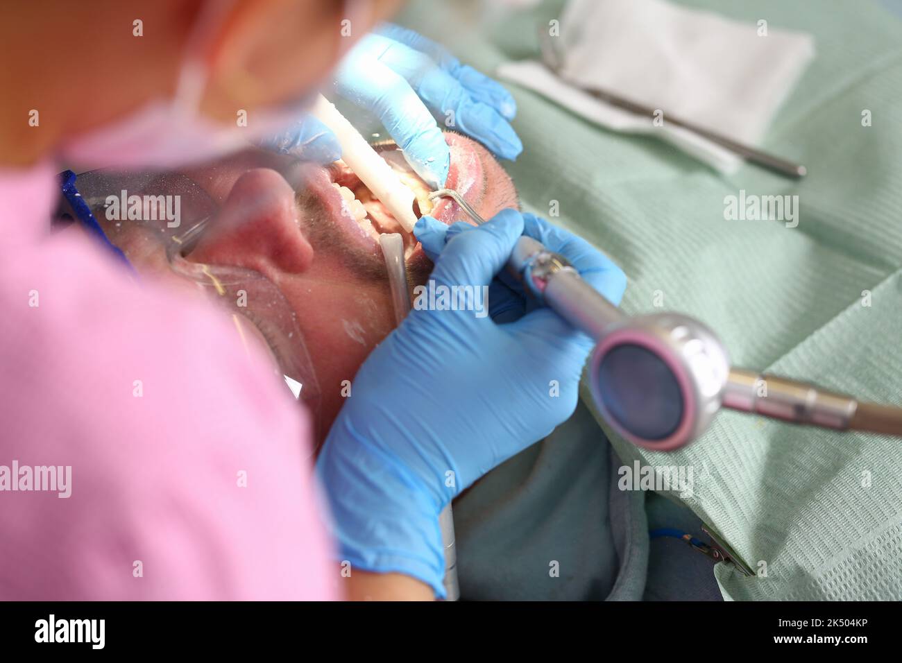 Patient with dentist checks teeth and drills tooth with caries Stock ...