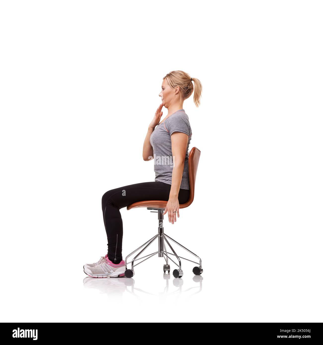 Perfect for your posture. a sporty woman doing stretches on a chair ...