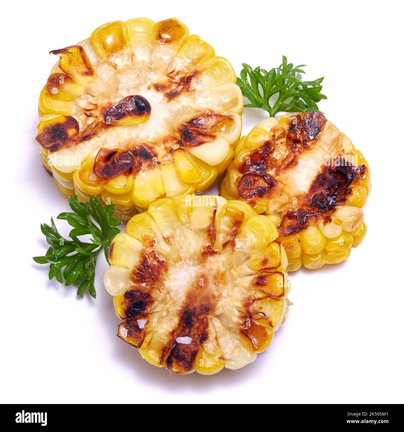 Grilled Slices of corn cobs with stripes from a grill isolated on white ...