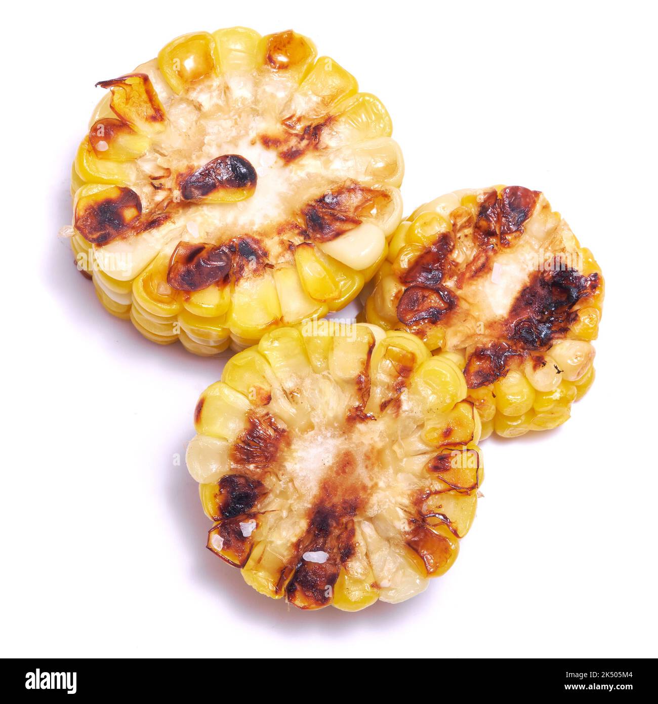 Grilled Slices of corn cobs with stripes from a grill isolated on white ...