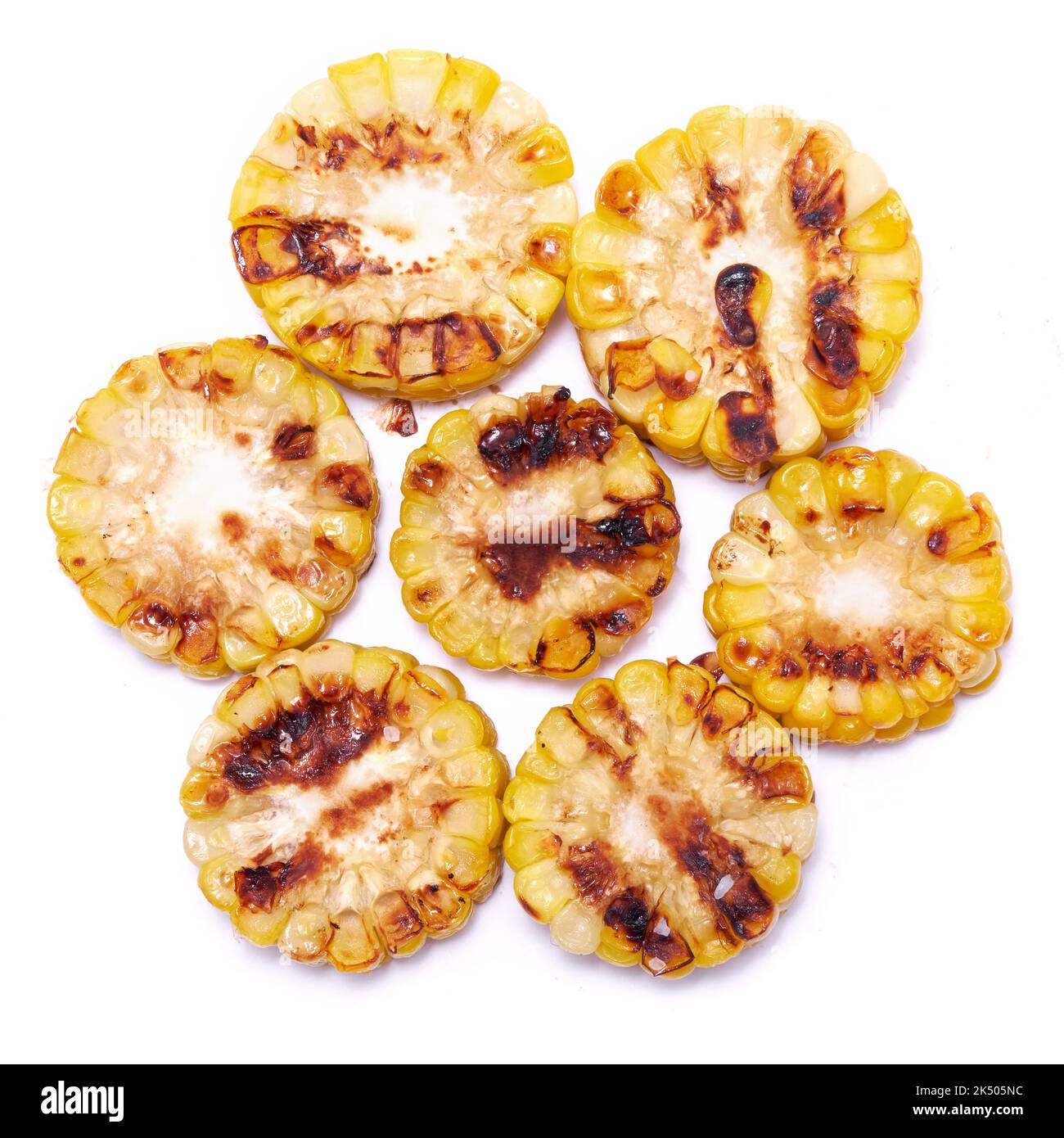 Grilled Slices of corn cobs with stripes from a grill isolated on white ...